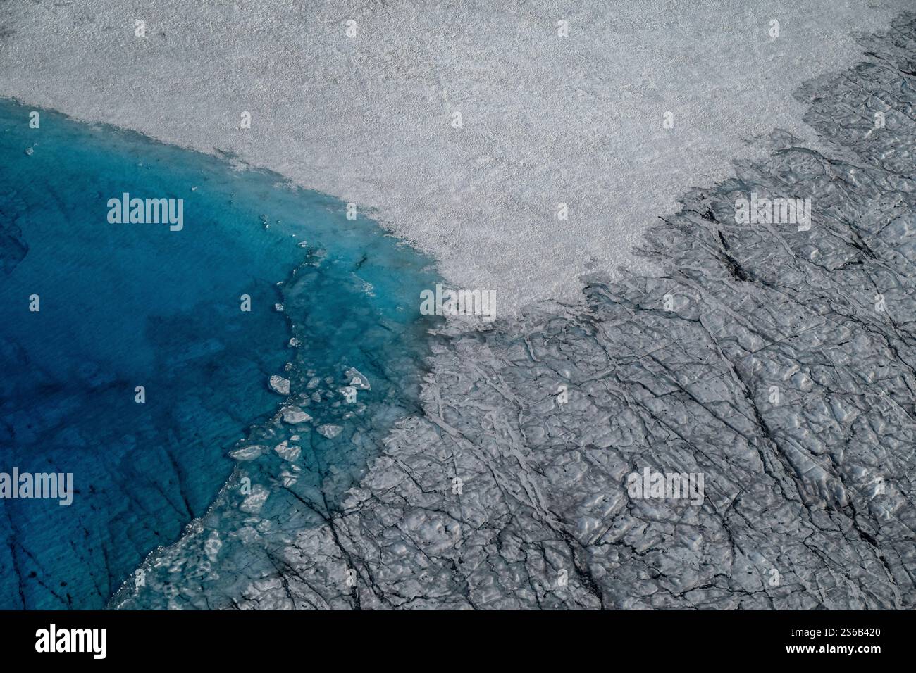 Bright blue pool forms on glacier surface during summer melt season ...