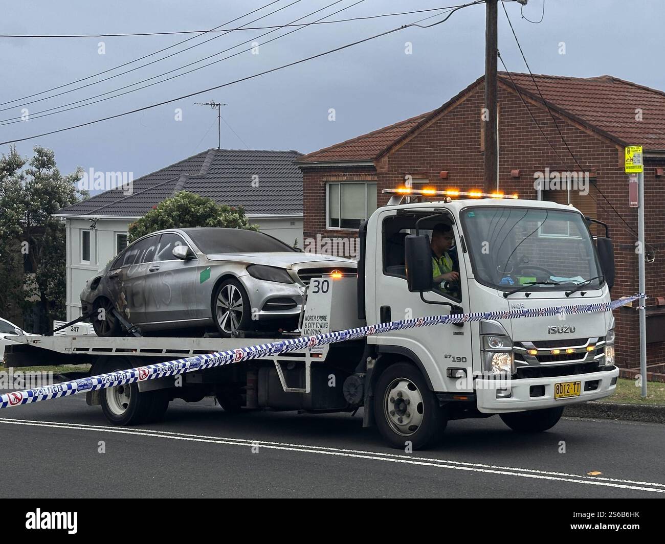 A burnt out car with anti-Semitic graffiti is towed away in Dover ...