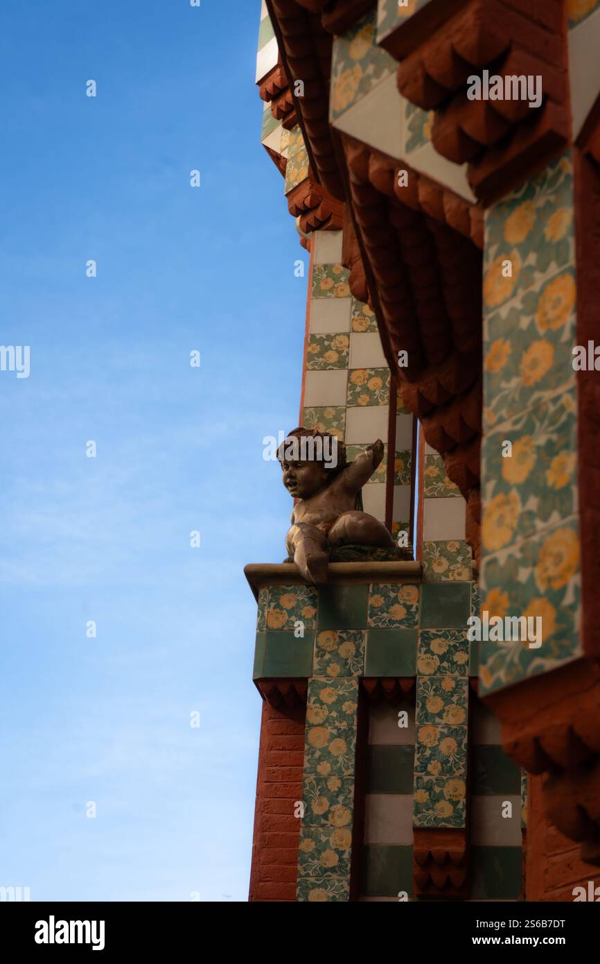 An angel sculpture adorning the exterior of Casa Vincens, exemplifying ...