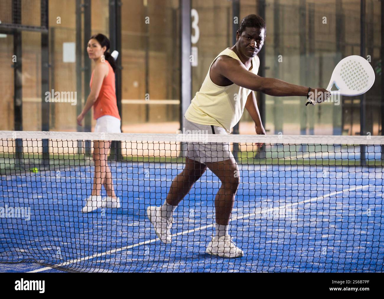African American hitting backhand during paddle match in close court ...