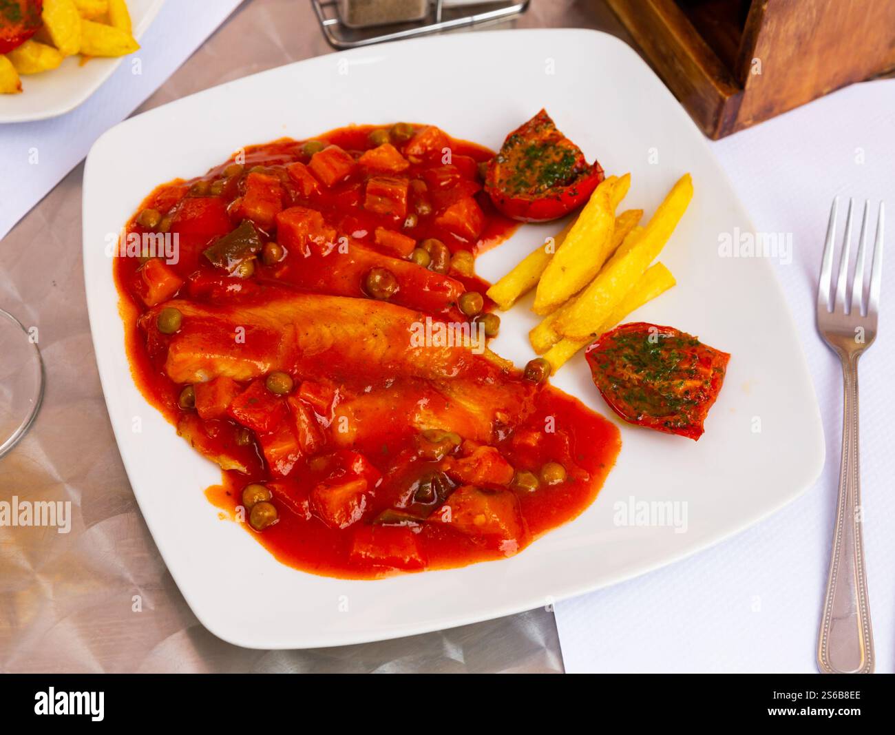 Tilapia fillet with vegetables, french fries and sun-dried tomatoes ...