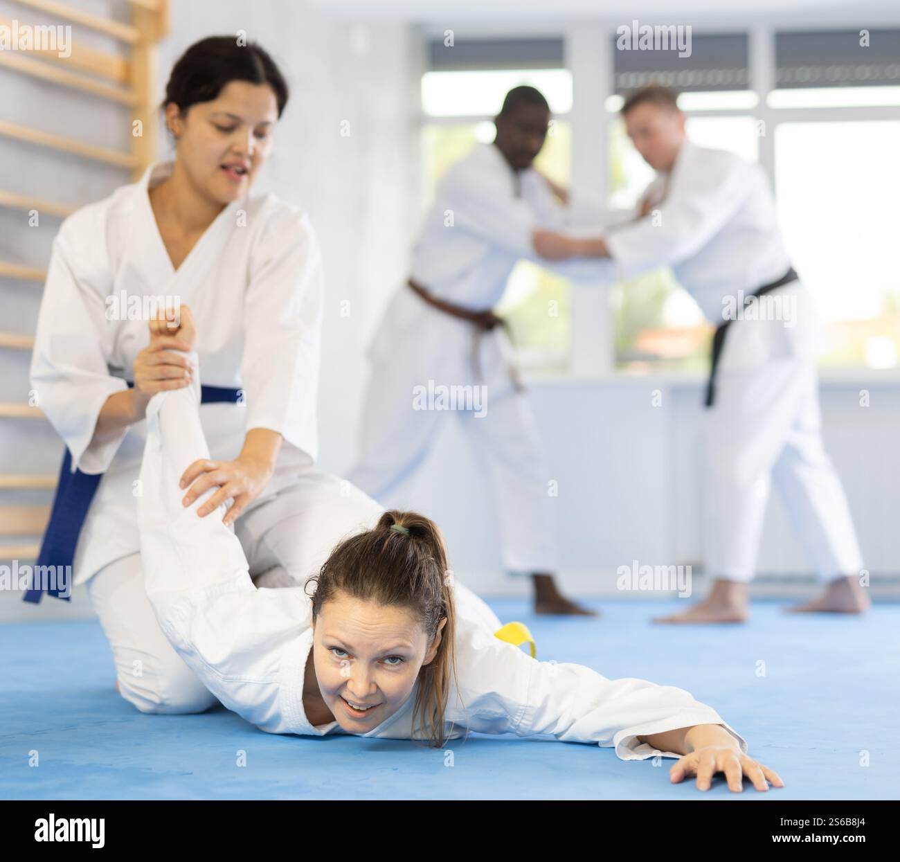 Adult and young women training judo techniques Stock Photo - Alamy