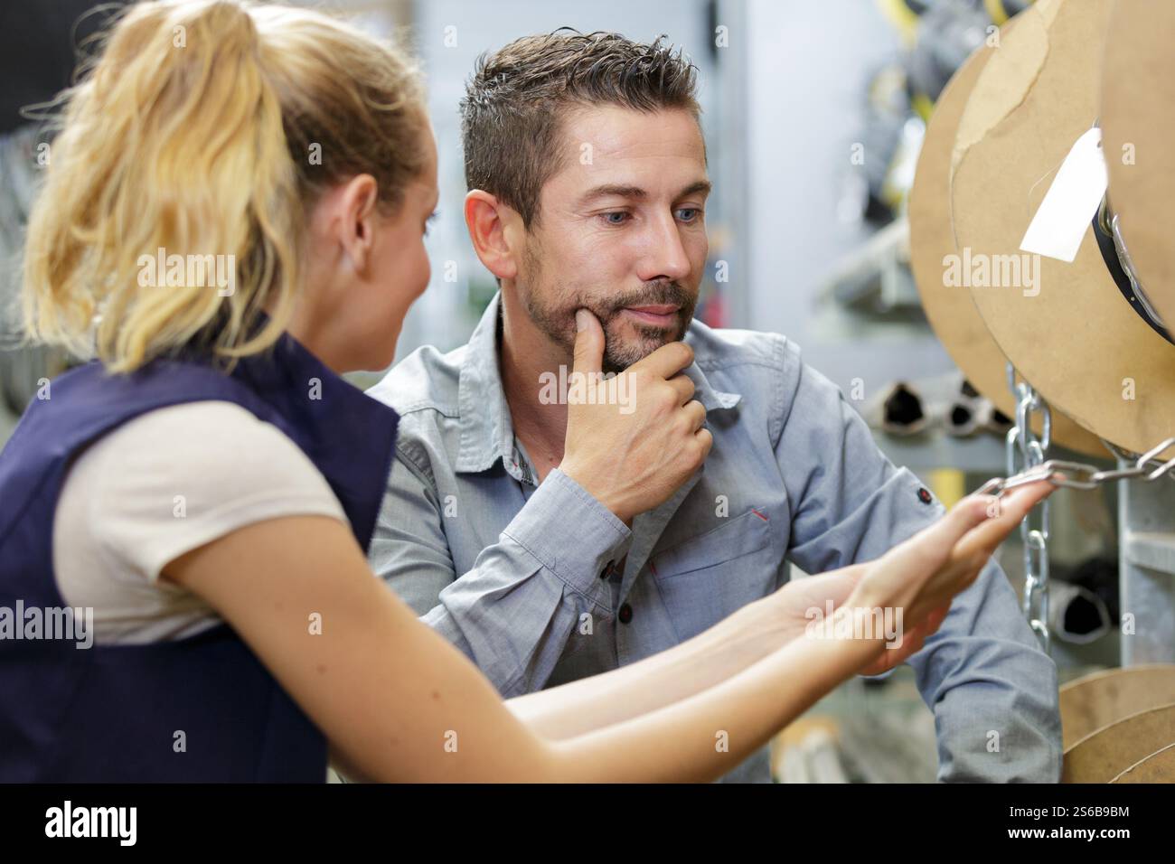 woman selling chains hardware store Stock Photo - Alamy