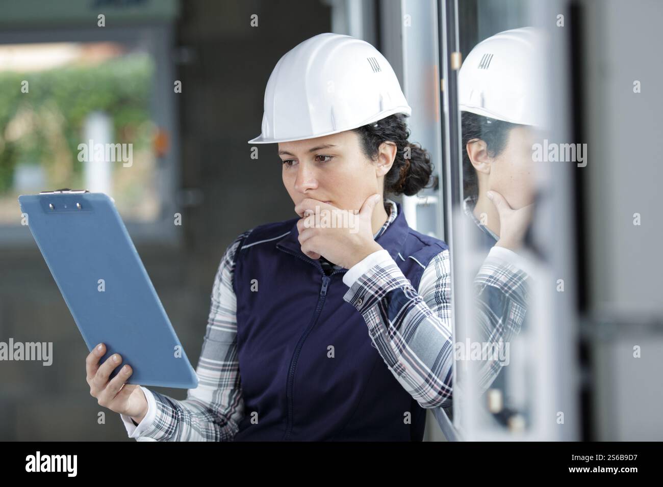 serious female building inspector looking at ceiling Stock Photo - Alamy