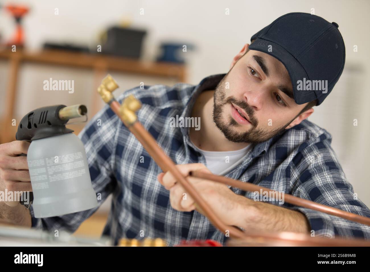 plumber using welding gas torch to solder copper pipes Stock Photo - Alamy