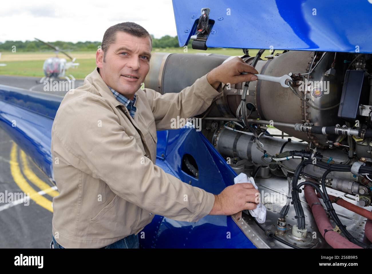 mechanic working on an aircraft in airfield Stock Photo - Alamy