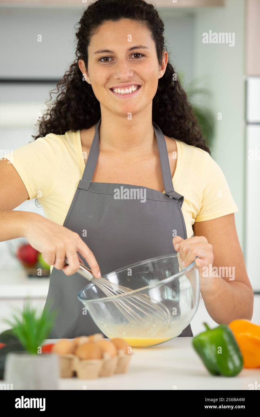 Happy young woman mixing hi-res stock photography and images - Alamy