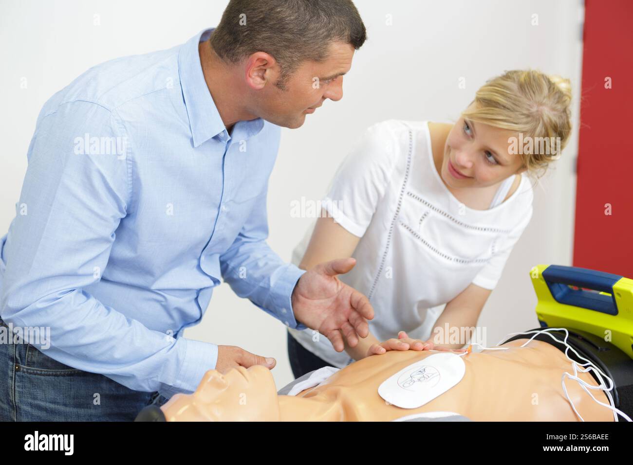 instructor demonstrating cpr chest compression on a dummy Stock Photo - Alamy