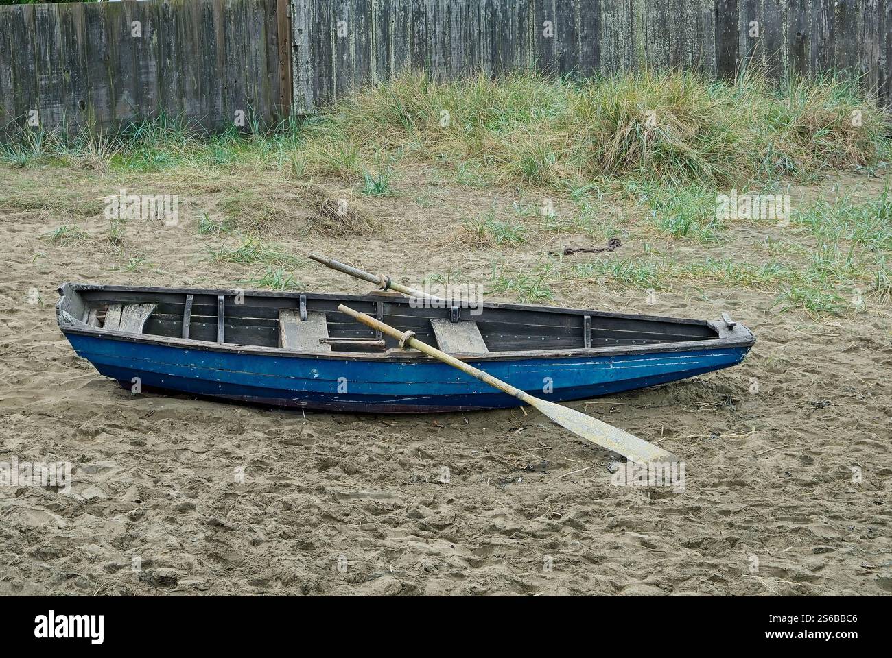 Beached wooden dory with oars Stock Photo - Alamy