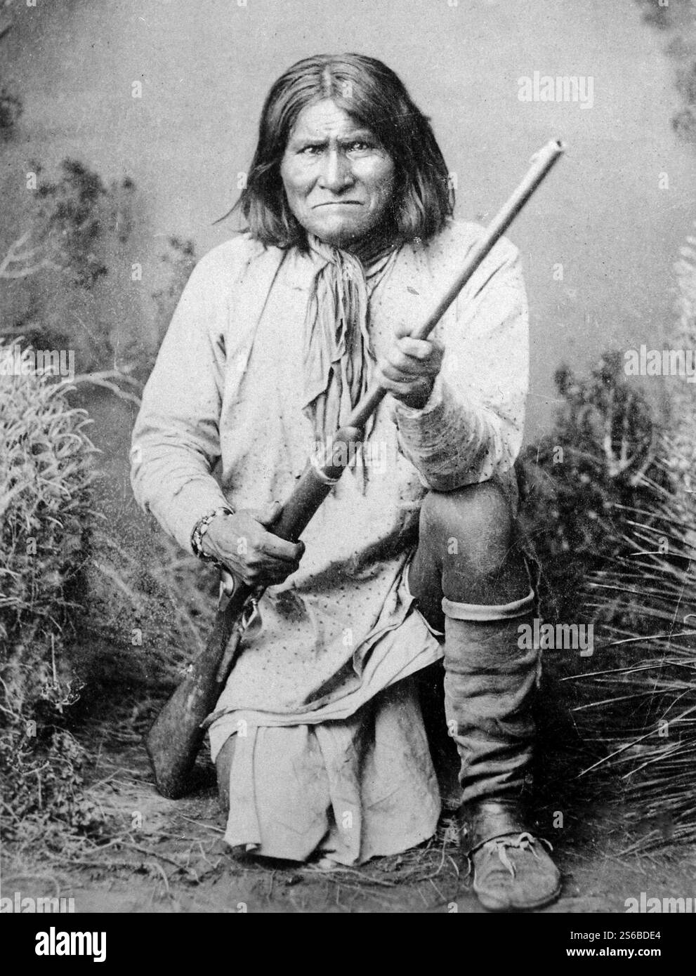 Geronimo (Goyathlay), a Chiricahua Apache, full-length, kneeling with ...