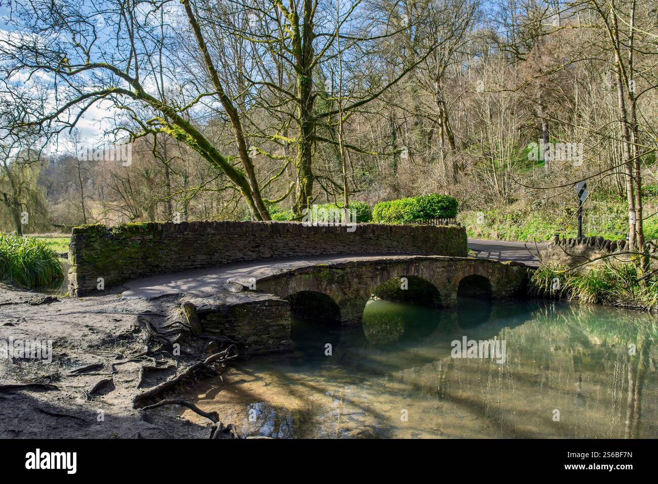 ByBrook River and stone bridge at Castle Combe village in the Cotswolds ...