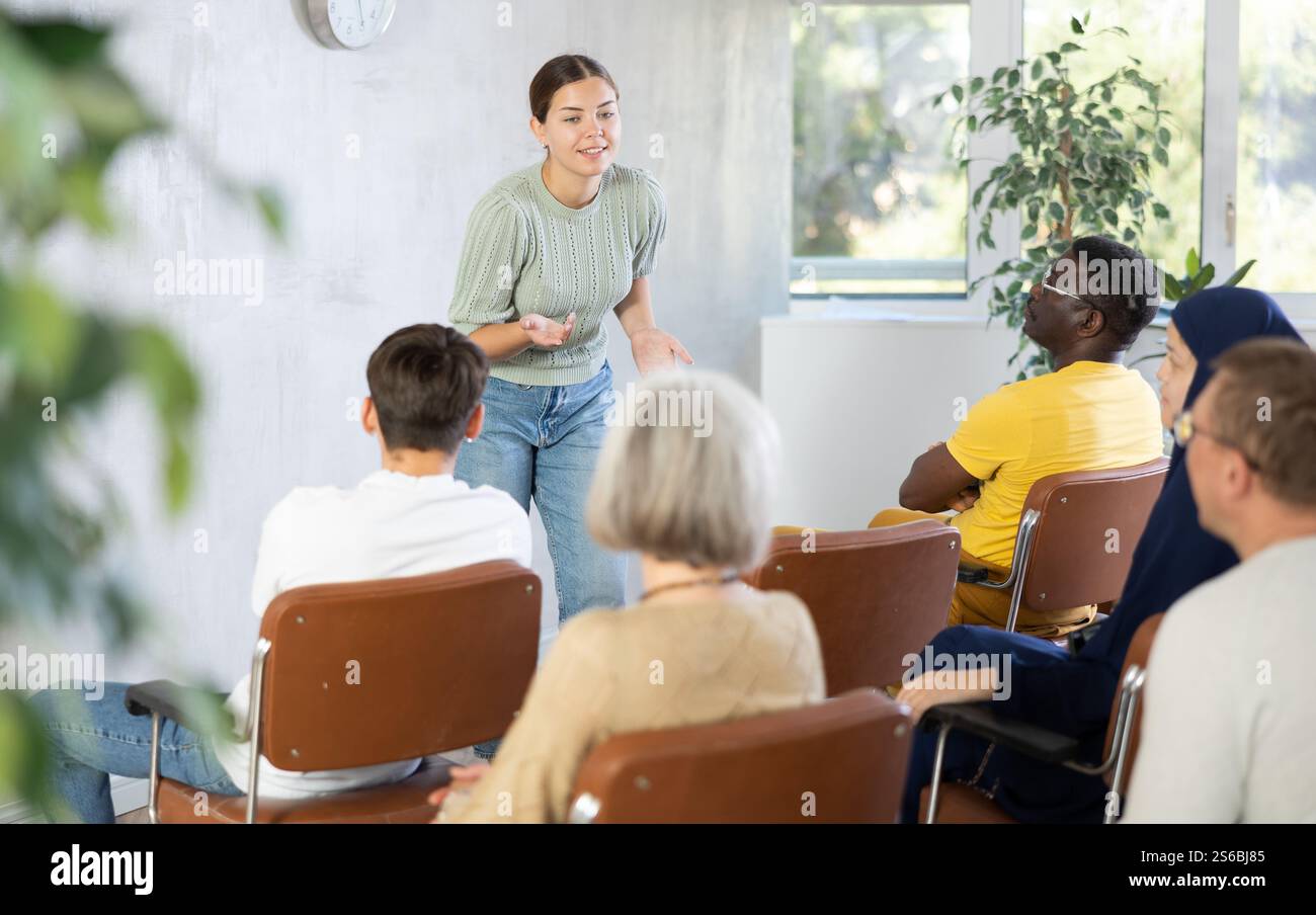 Woman tells an interesting story. Multinational students listening ...