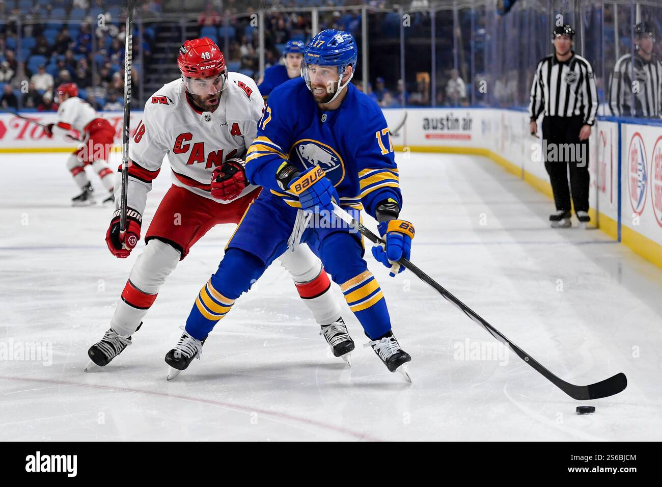 Buffalo Sabres left wing Jason Zucker, right, looks to pass the puck ...