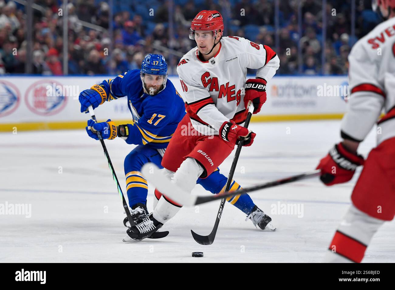 Carolina Hurricanes center Martin Necas, right, shields the puck from ...