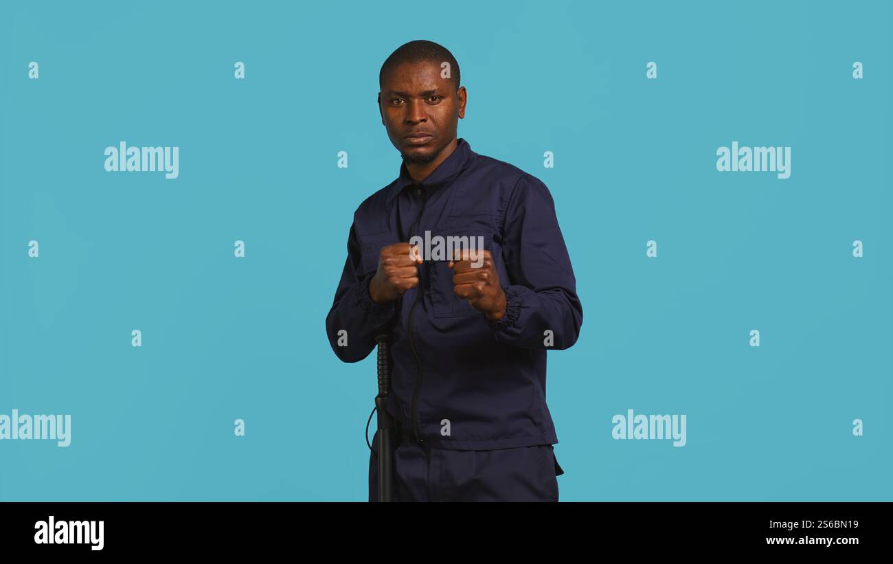 Security guard standing in fighting stance, prepared to deal with ...
