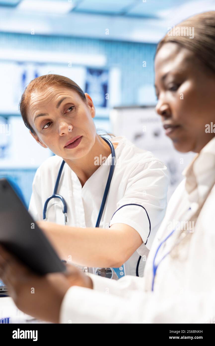 Healthcare professionals staff gather in a clinic to analyze x ray data ...
