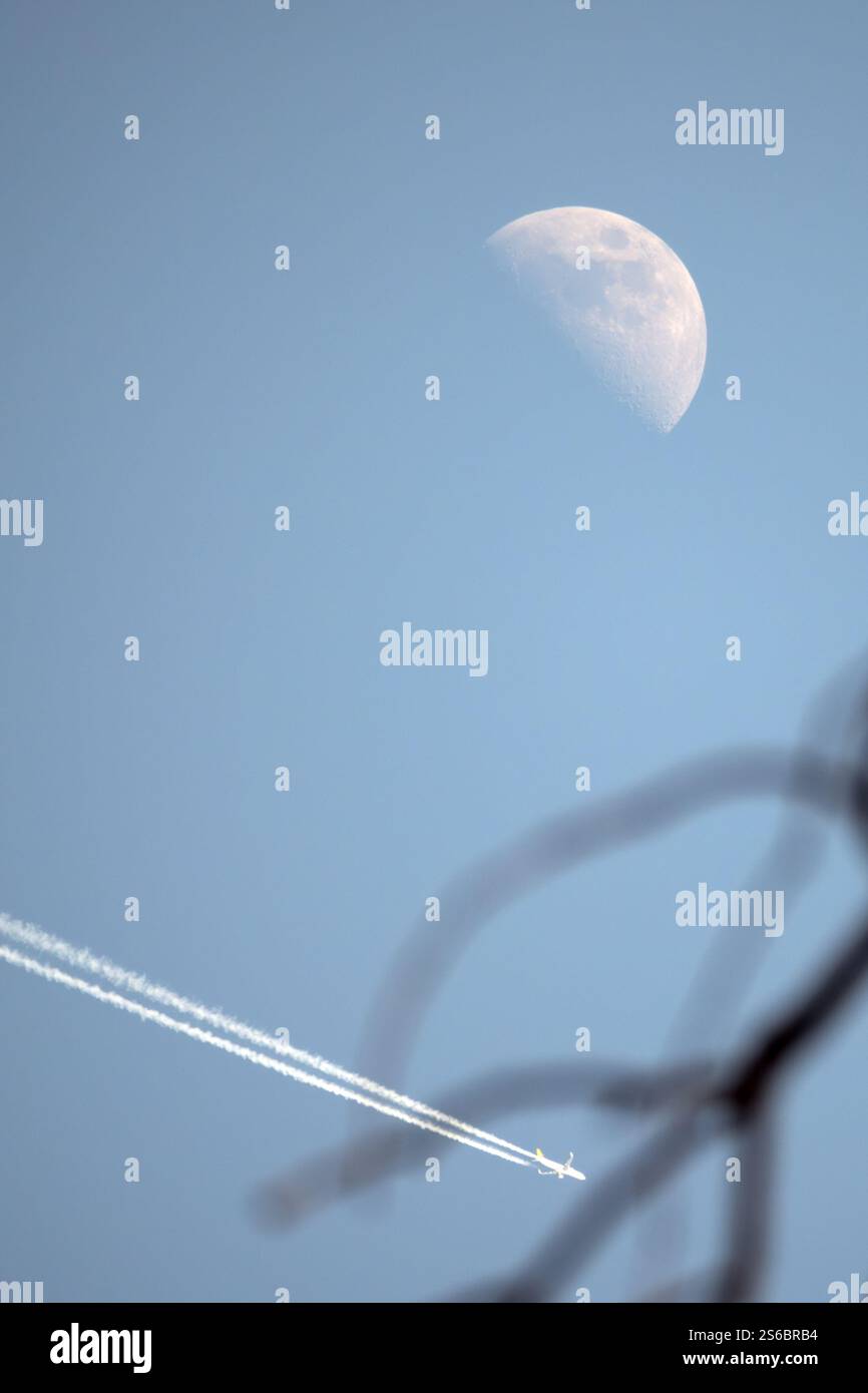 Airliner flying under moon hi-res stock photography and images - Alamy