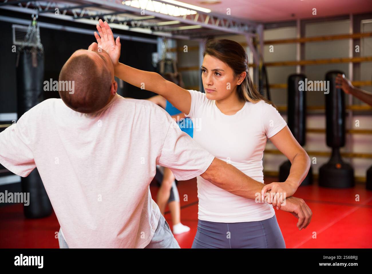 Man and woman practicing self-protection moves in gym Stock Photo - Alamy