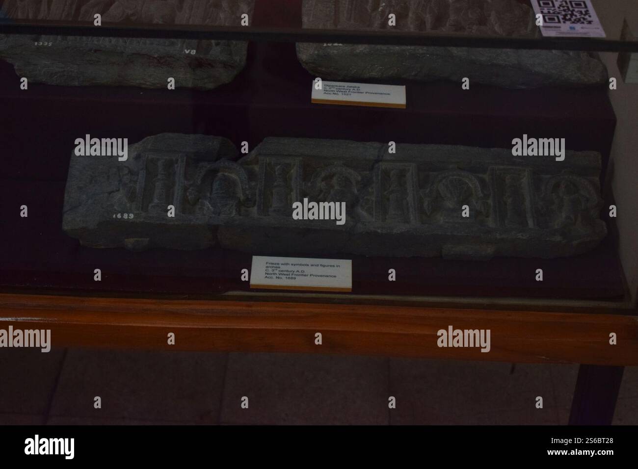 Frieze with symbols and figures in arches Stock Photo - Alamy