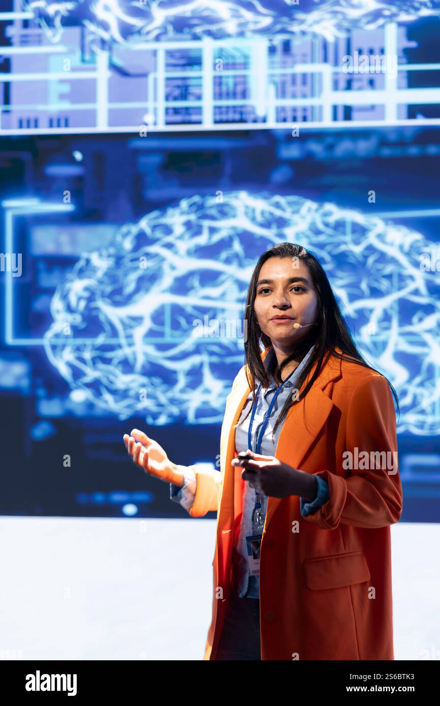 Presenter talking in front of world leading technology experts and researchers meeting at ...