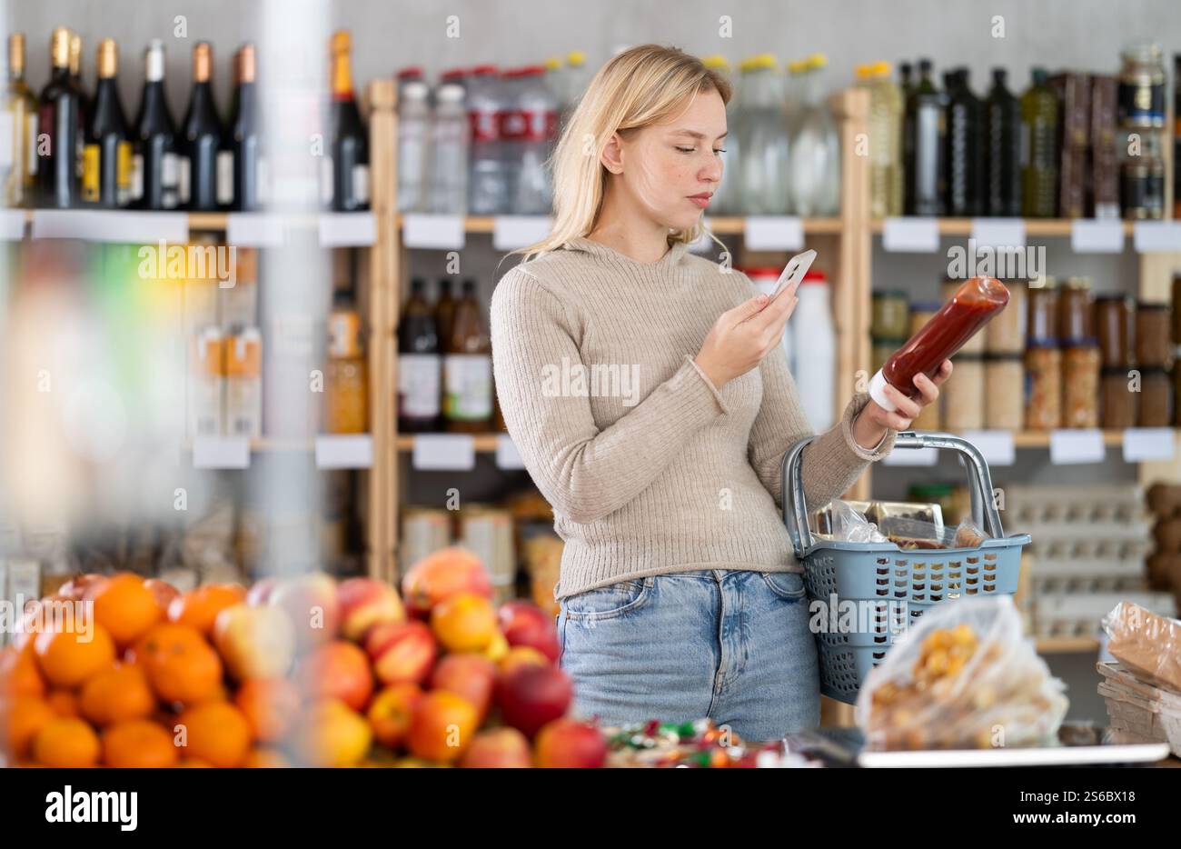 Young woman scanning qr code for ketchup Stock Photo - Alamy