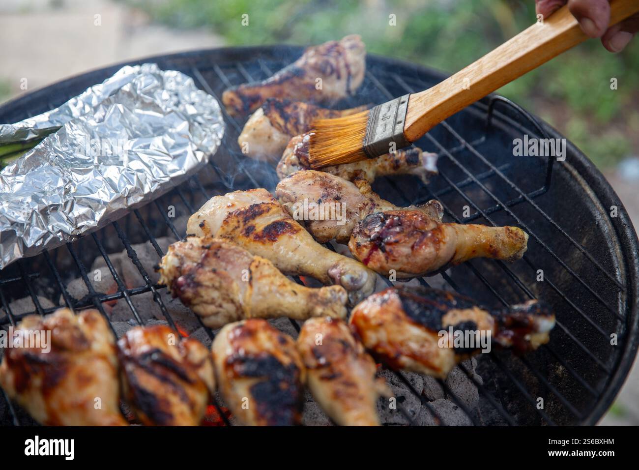 Chicken legs on the BBQ heated by coals Stock Photo - Alamy
