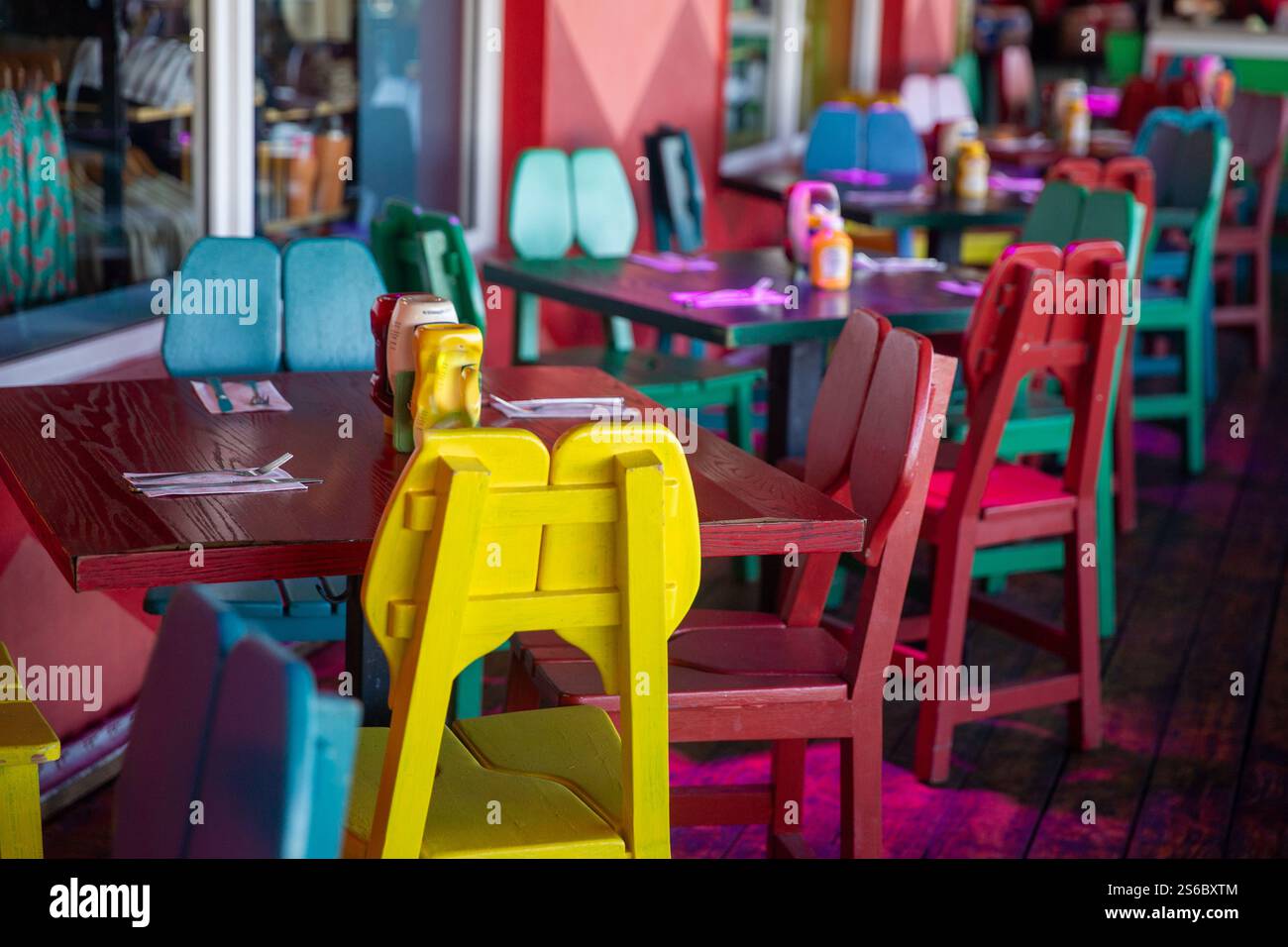 Colorful Tables and Chairs at a bar in the bahamas Stock Photo - Alamy