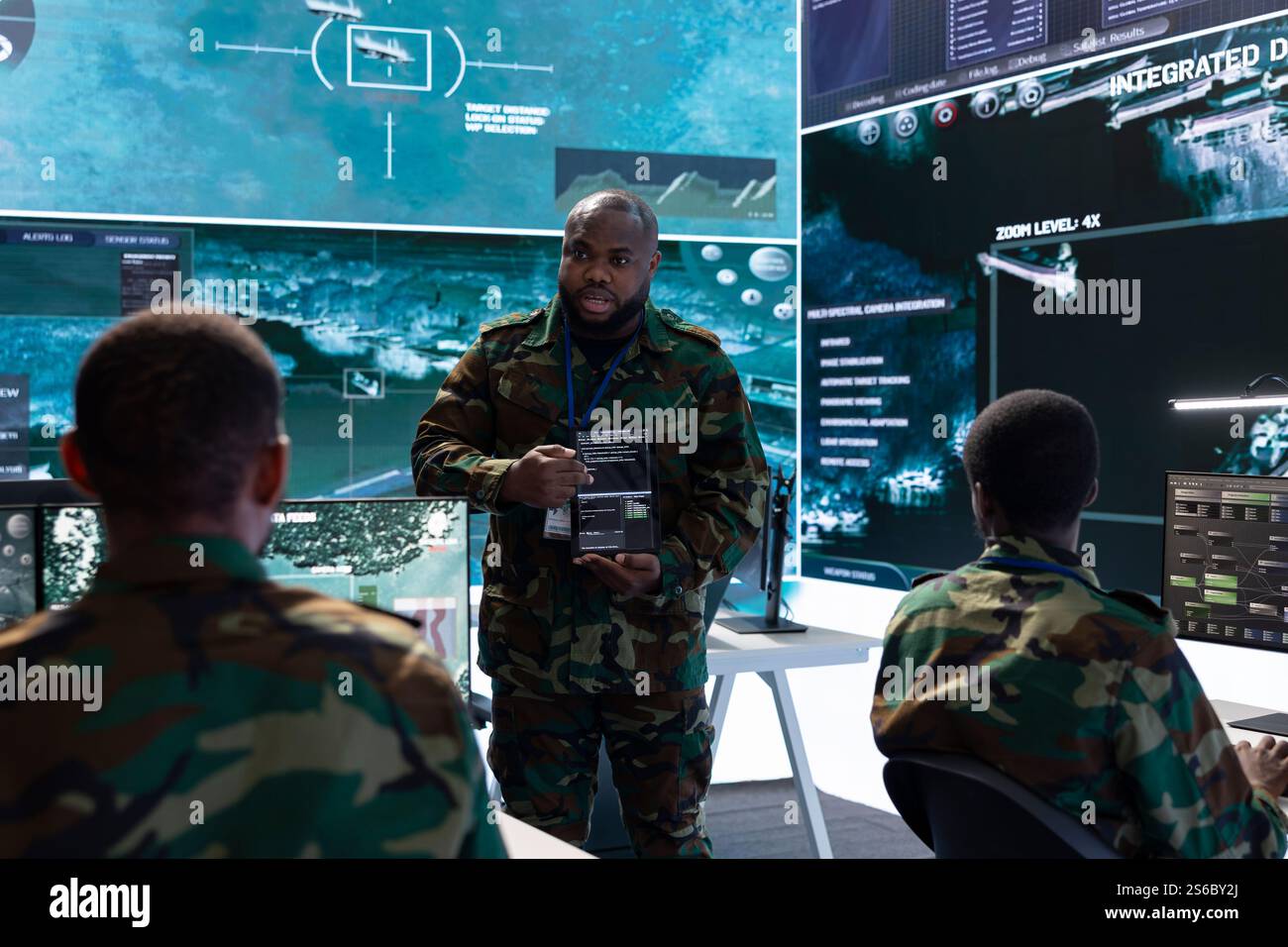 Military team operating in a high tech command post control tower, focusing on surveillance ...