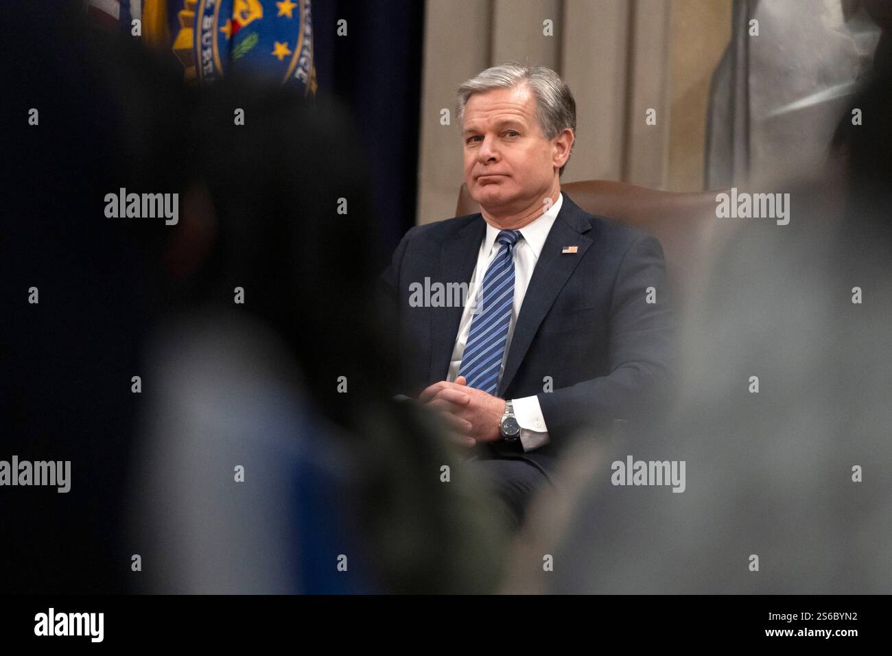 FBI Director Christopher Wray sits during a farewell ceremony for ...