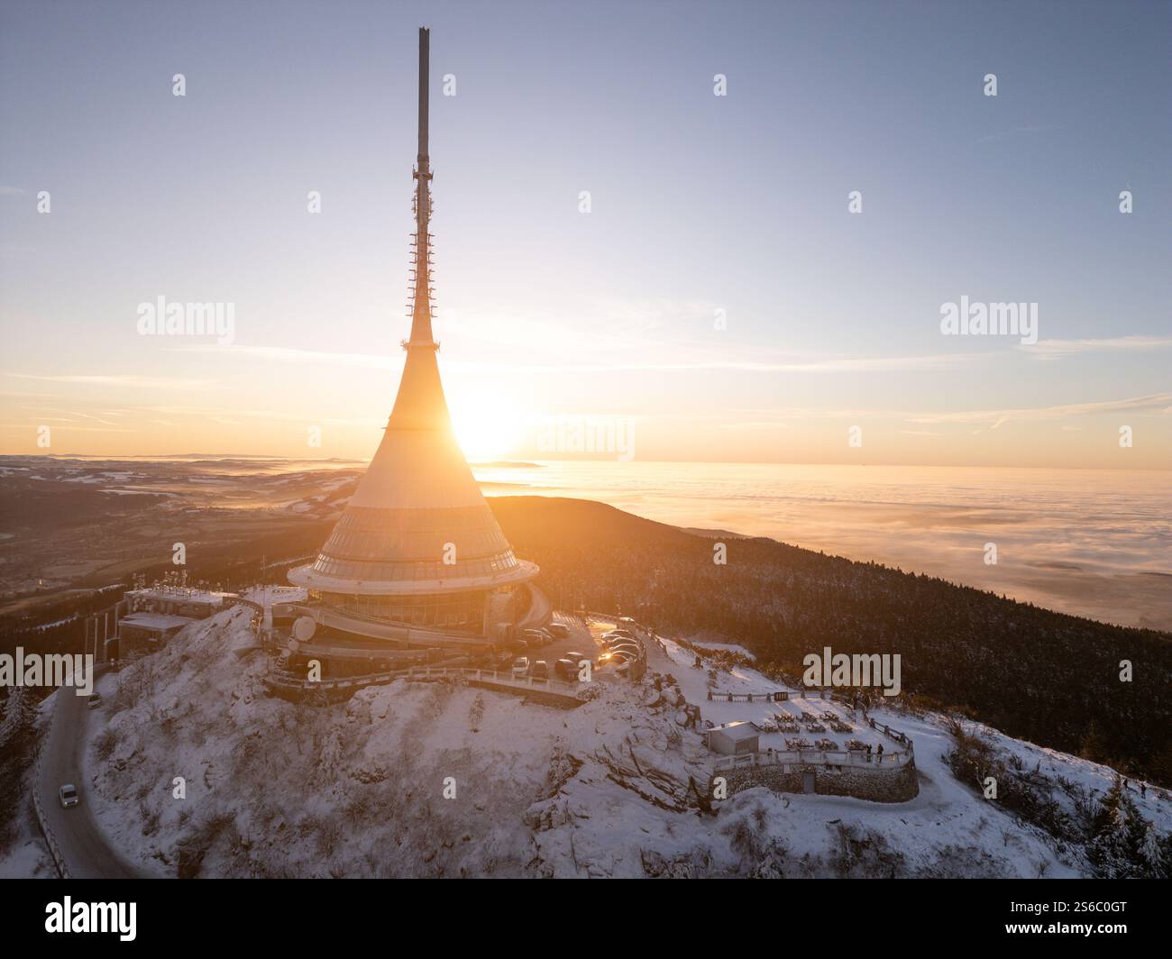 At sunrise, the snow-covered Jested Mountain showcases its unique ...