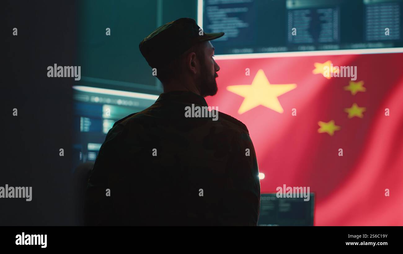 Chinese military personnel in a high tech government hacking room work ...