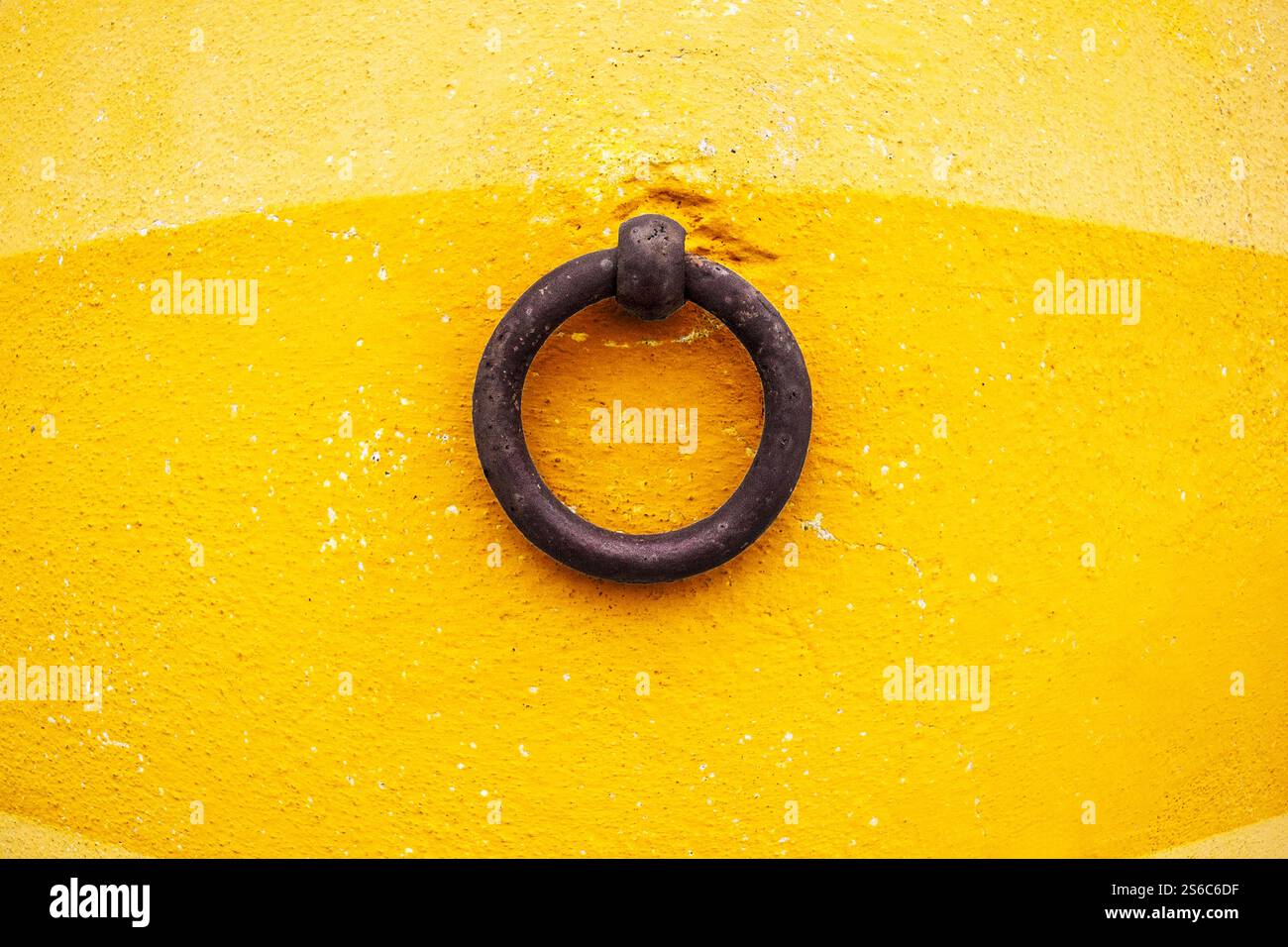 Rusted metal ring on yellow exterior wall Stock Photo - Alamy