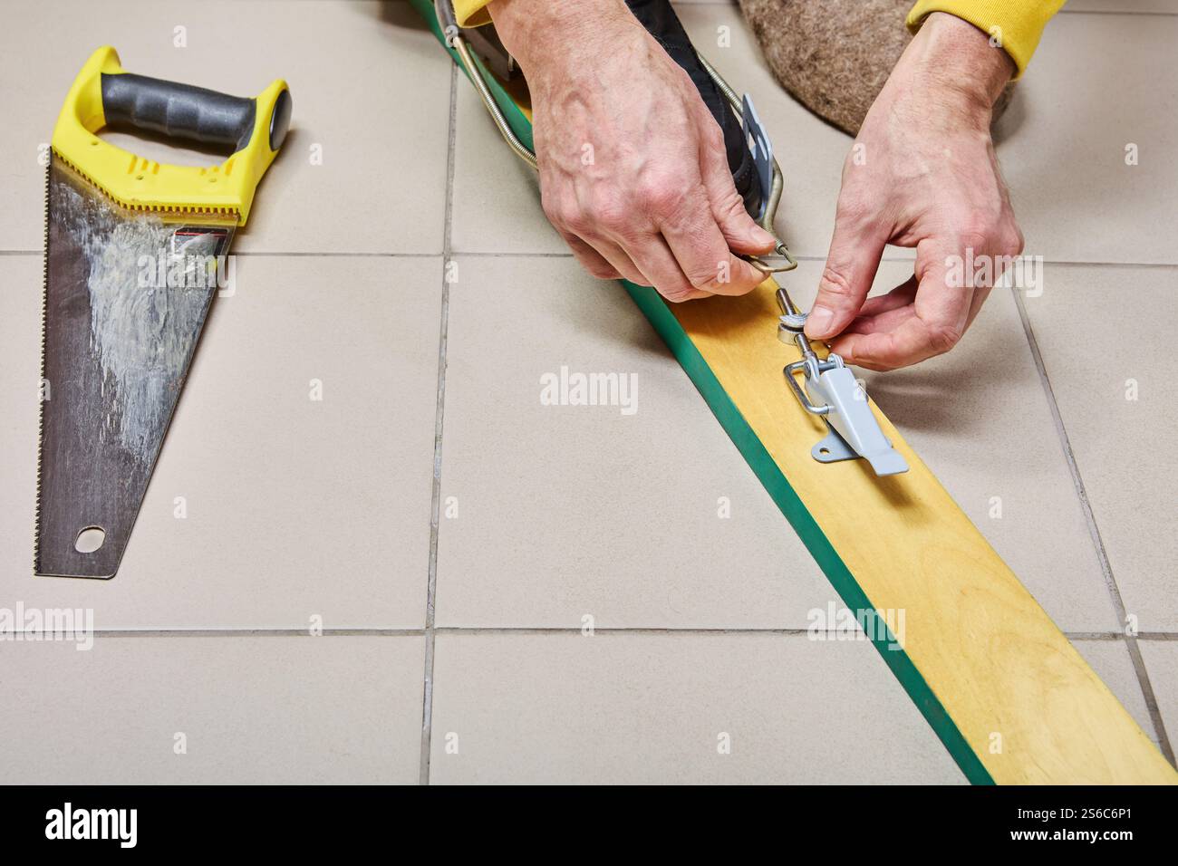 Adjusting tension arm of cable ski binding during installation Stock ...