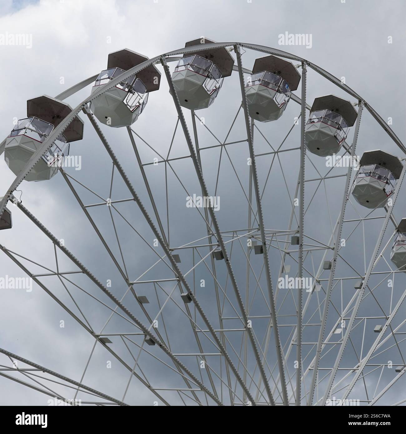 Ferris wheel in front of dark clouds of a rain front: detailed shot of ...