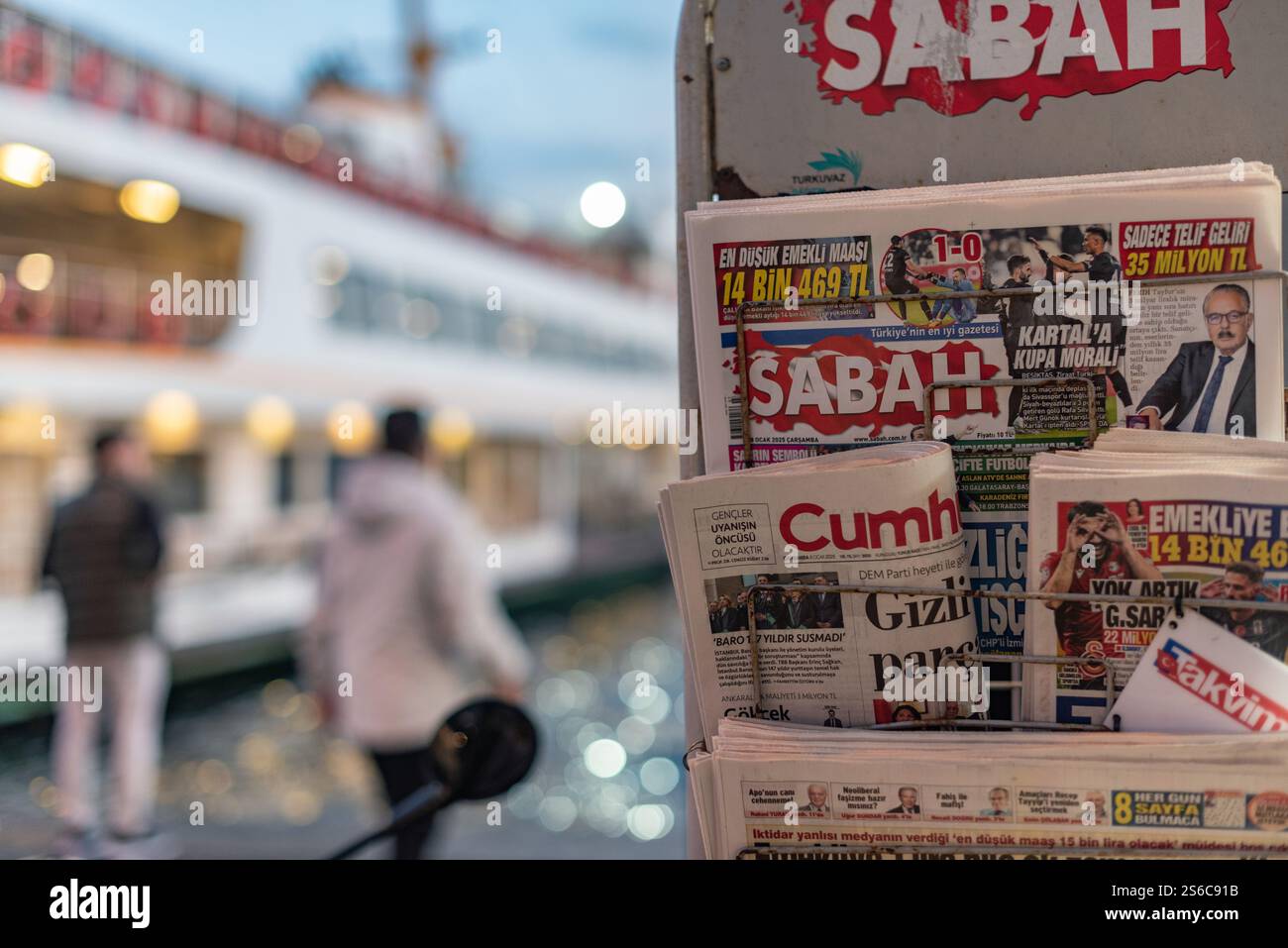 Turkish daily newspapers displayed on a stand at Karakoy Ferry Station ...