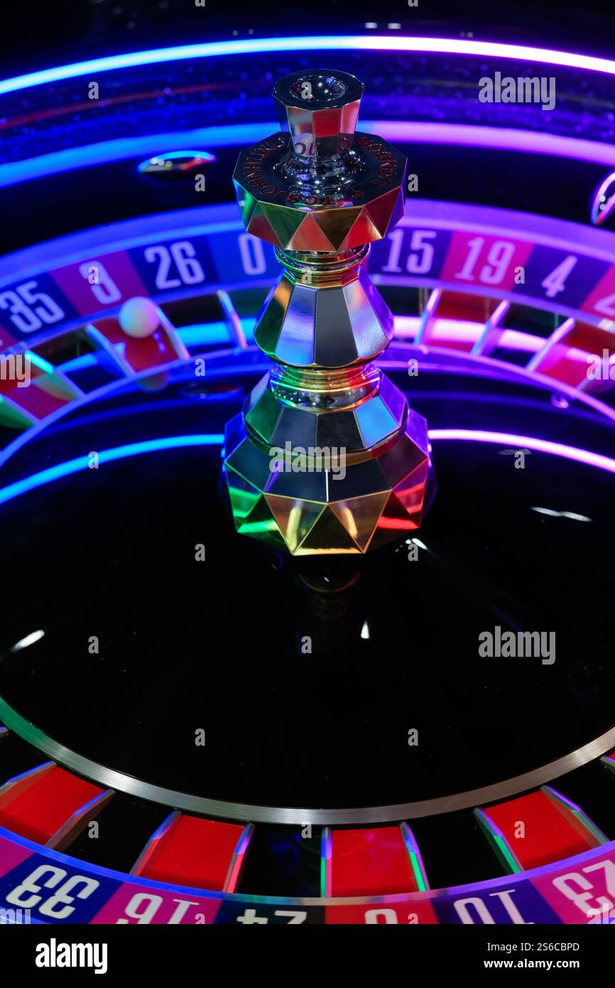 Glass spindle on a colourfully lit roulette wheel Stock Photo - Alamy
