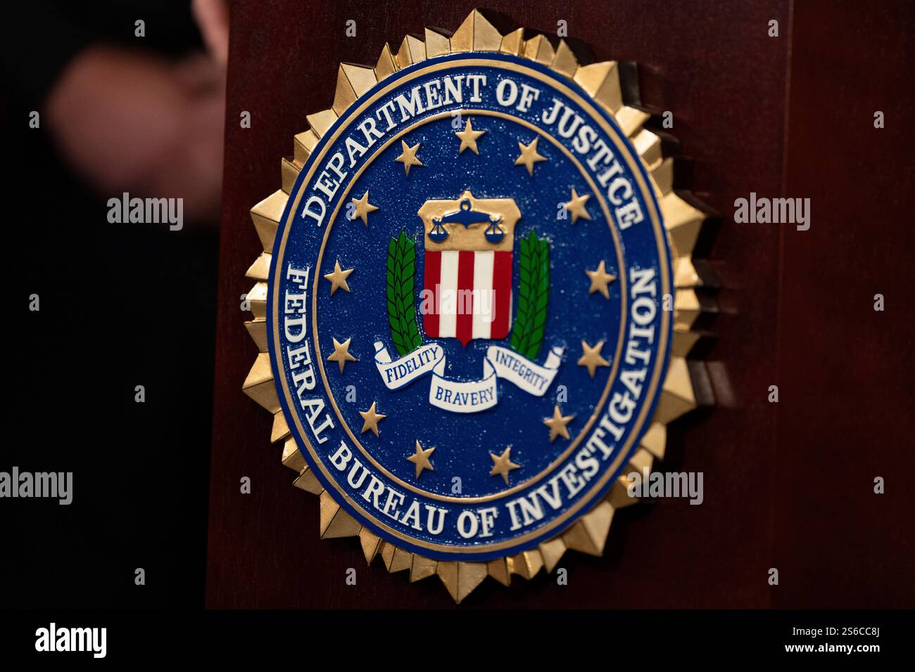 An FBI seal is displayed on a podium during a news conference at the ...