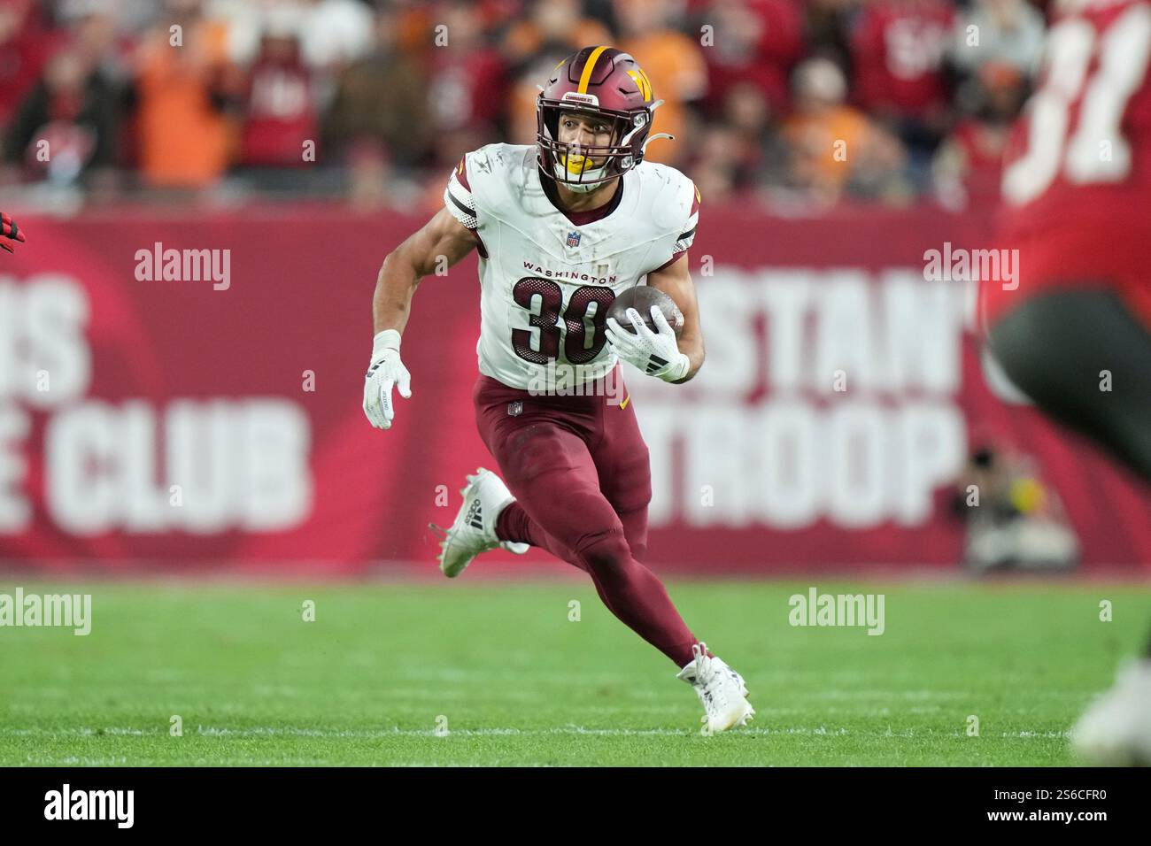 Washington Commanders running back Austin Ekeler (30) runs after a catch during an NFL football ...