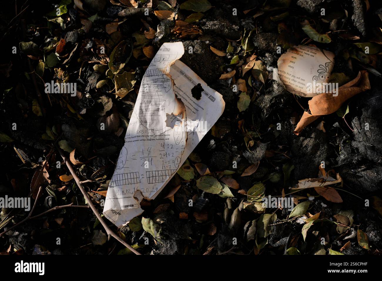 Burnt school worksheets are seen on the ground outside of an elementary ...