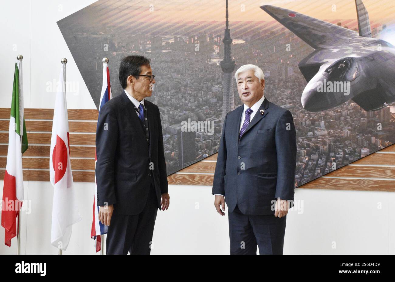 Japanese Defense Minister Gen Nakatani (R) is briefed by Masami Oka ...