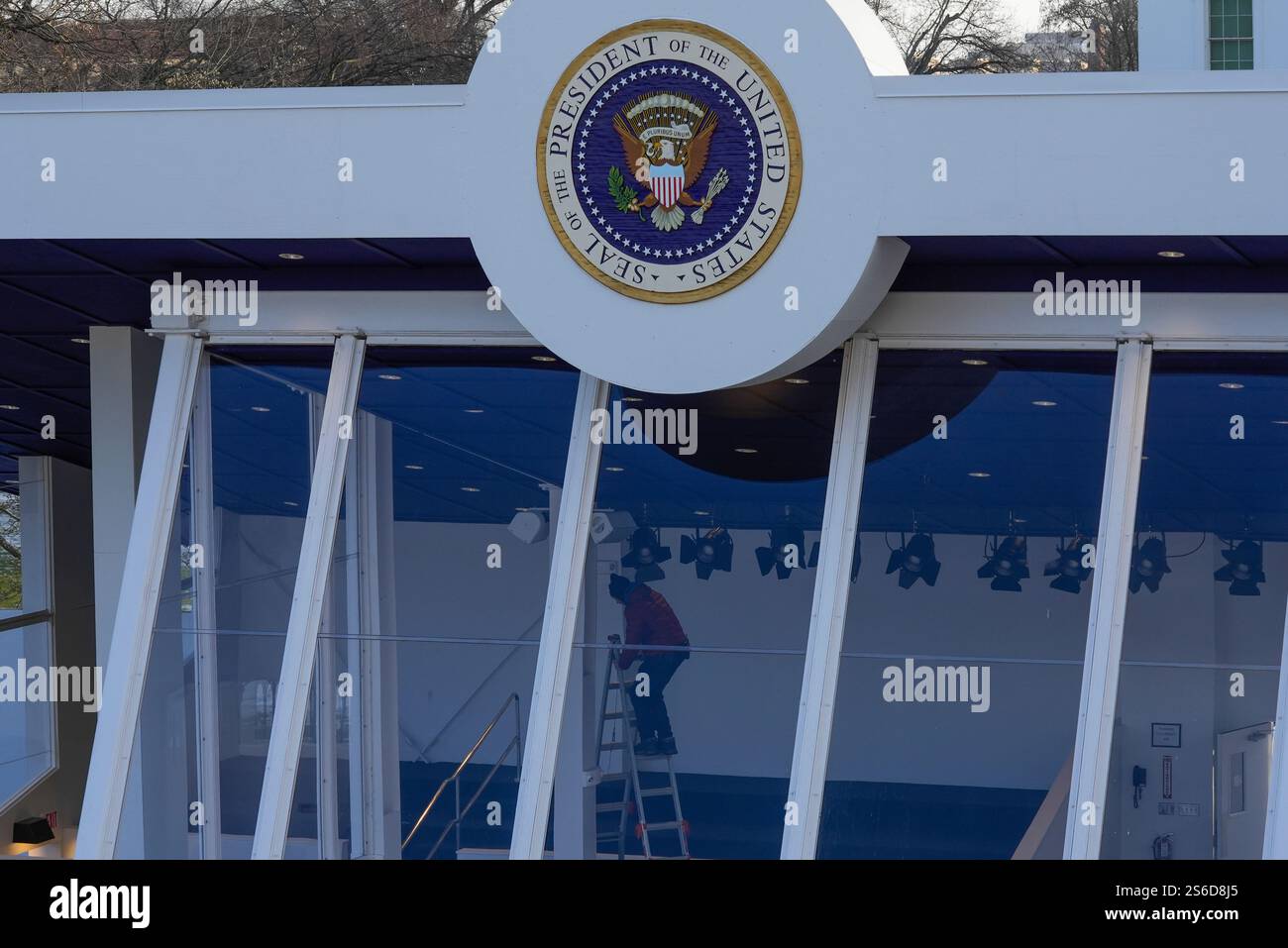 A worker continues with the finishing touches on the presidential ...