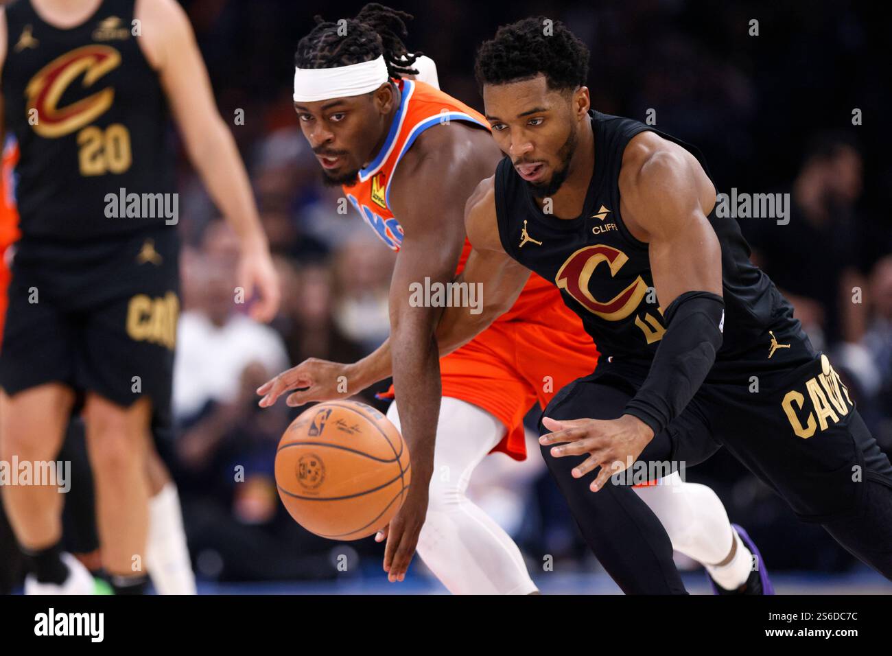 Oklahoma City Thunder guard Luguentz Dort, left, and Cleveland Cavaliers guard Donovan Mitchell ...