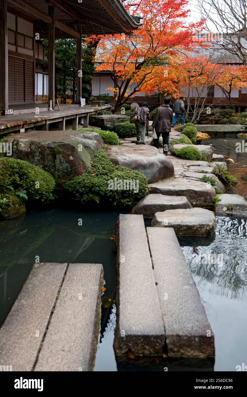 Stone walkway over pond at National Treasure Hyakusaiji Temple, one of ...