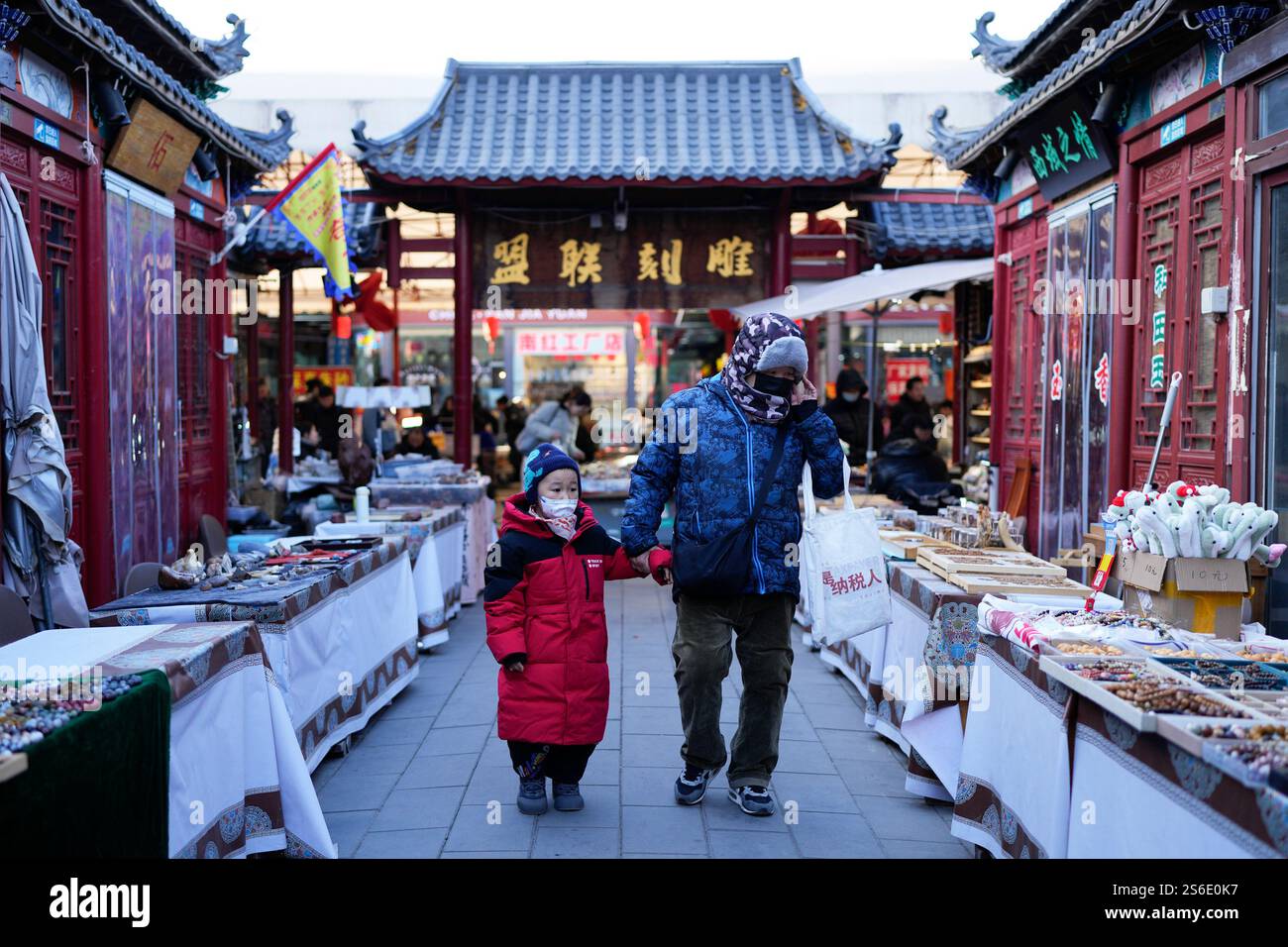 A boy and a woman shop at a market in Beijing, Thursday, Jan. 16, 2025 ...