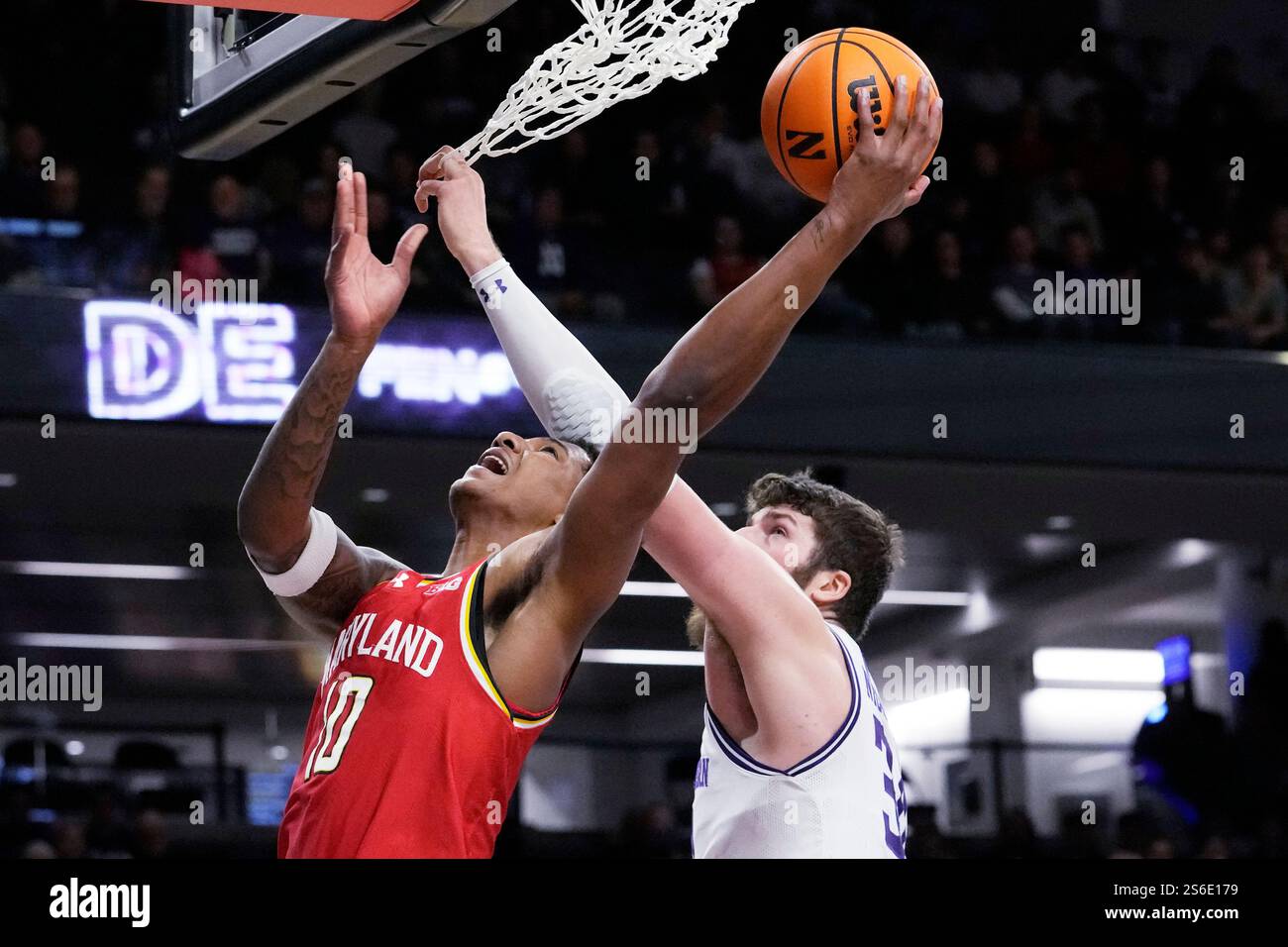 Maryland forward Julian Reese, left, shoots against Northwestern center ...