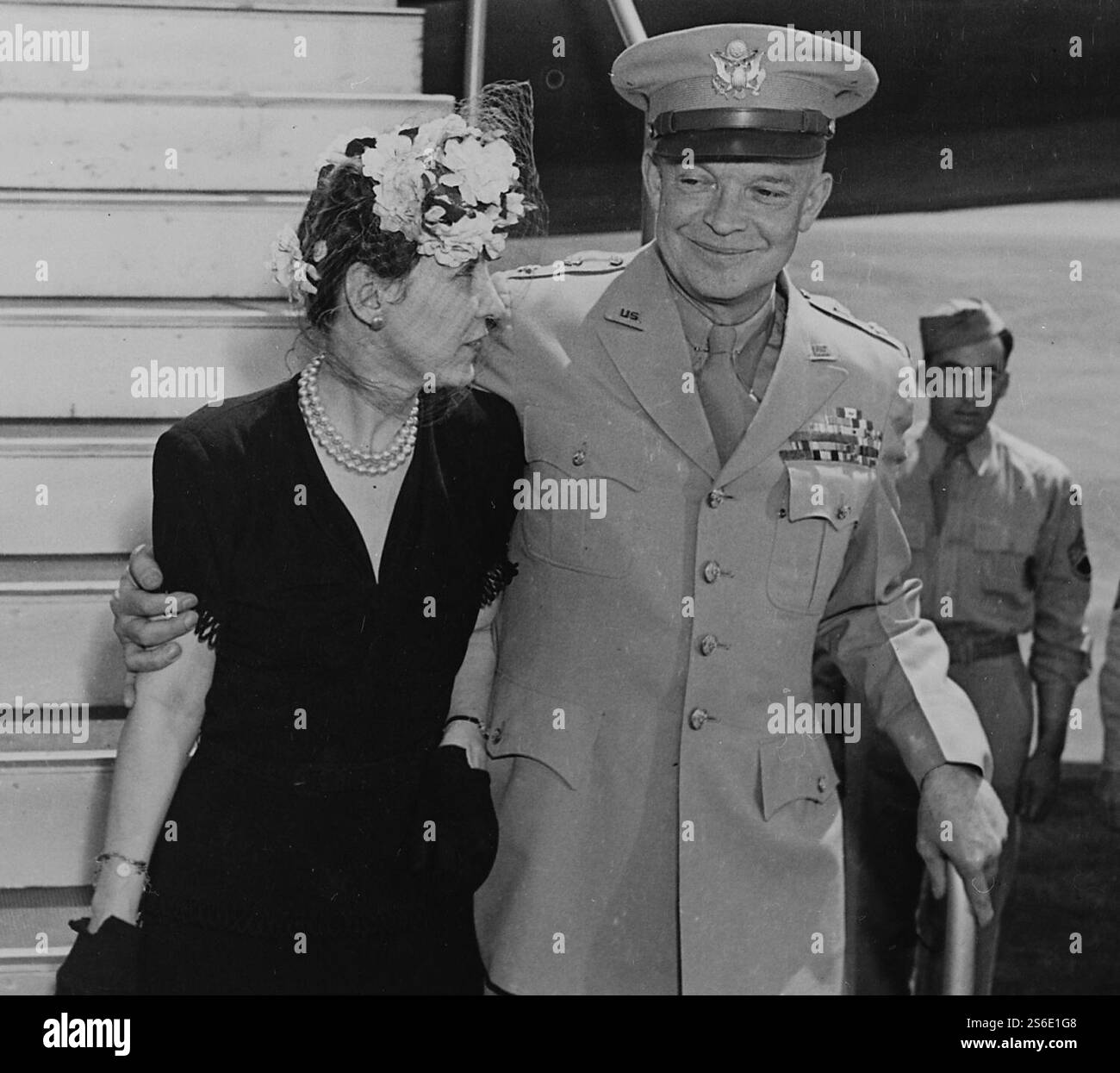 General Dwight D. and Mamie Eisenhower descending an airplane ramp, on ...