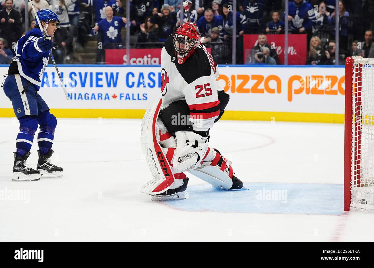 Toronto Maple Leafs' William Nylander, left, scores against New Jersey ...