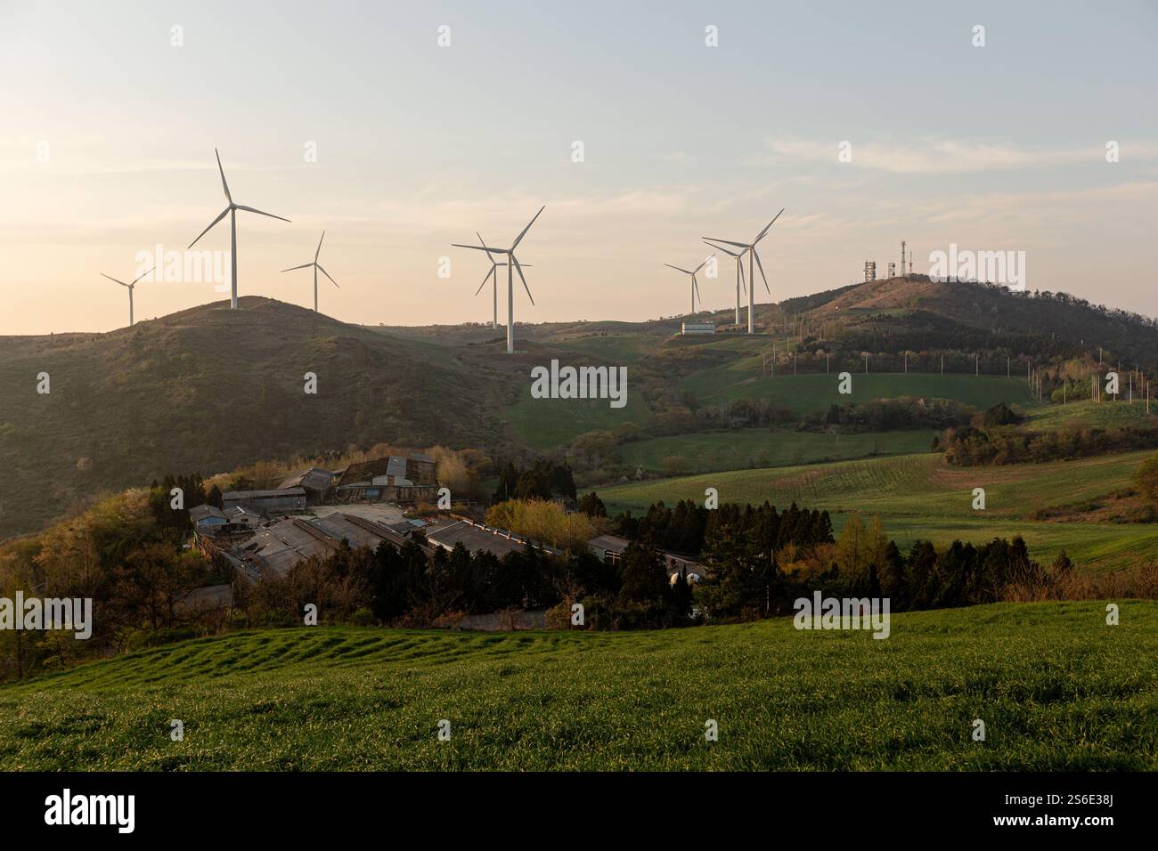 A beautiful farm with wind turbines, mountain and field sunrise Stock ...