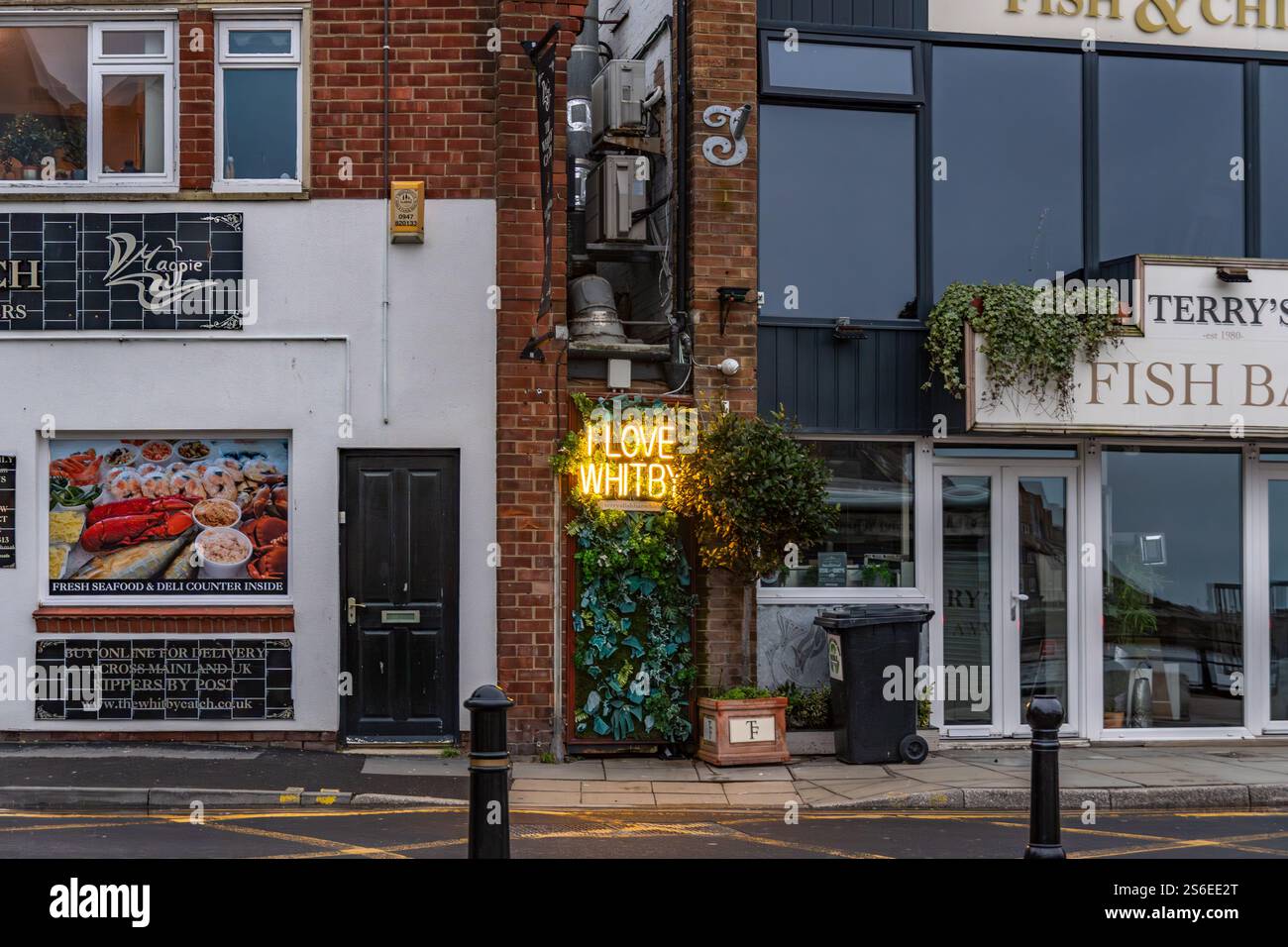 Whitby, England, UK - Jan 12, 2024: Storefronts with I Love Whitby neon ...