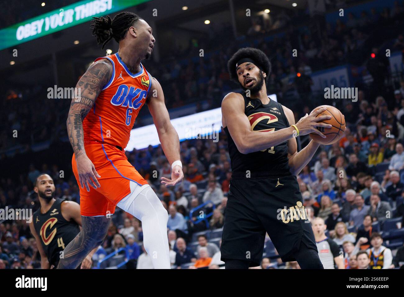 Cleveland Cavaliers center Jarrett Allen, right, grabs a rebound next ...